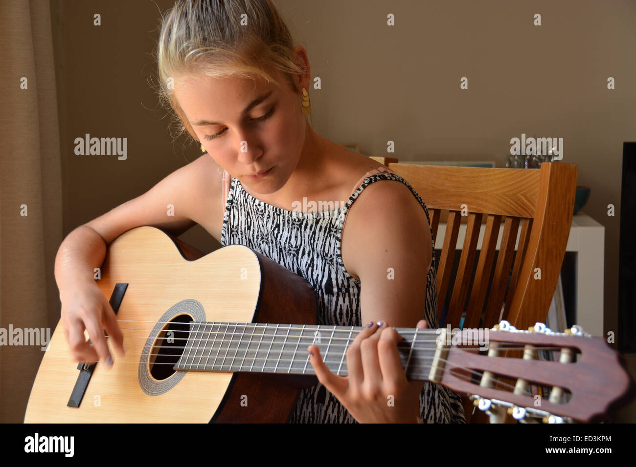 Young female student playing guitar Stock Photo - Alamy