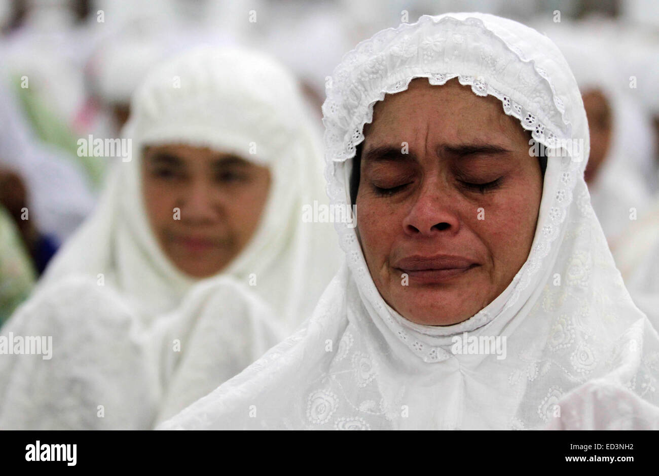 Aceh, Indonesia. 25th Dec, 2014. Indonesian Muslim women participate in ...