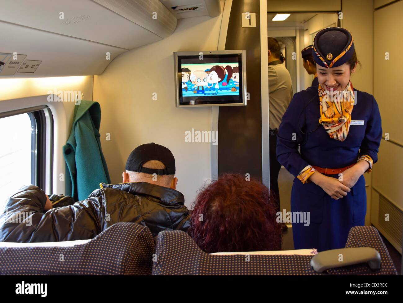 Urumqi. 26th Dec, 2014. A steward works in a bullet train on the Lanxin ...