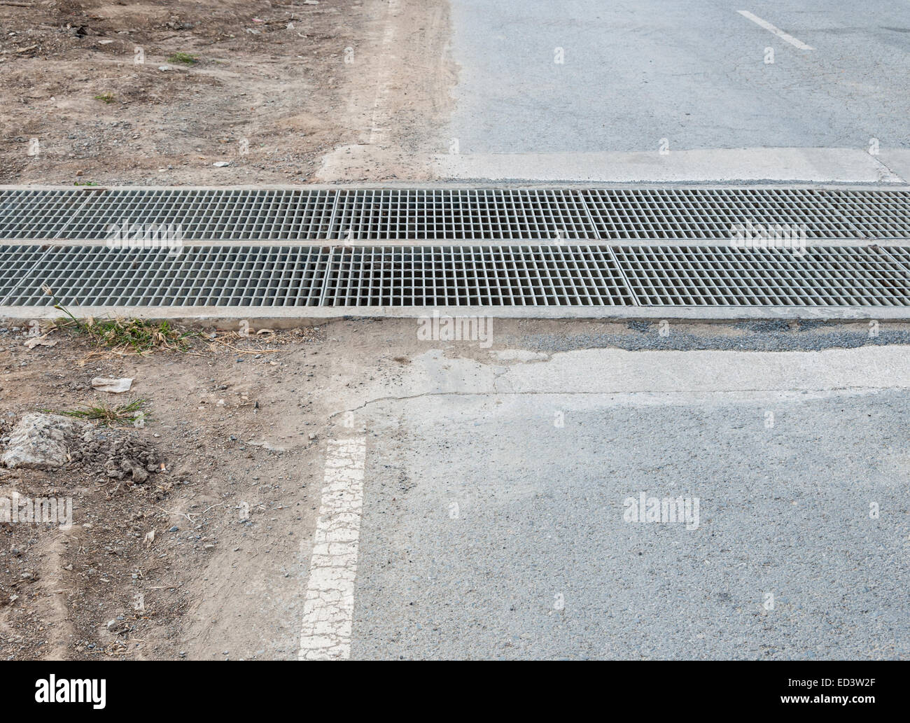 Old steel drainage of the asphalt road Stock Photo - Alamy