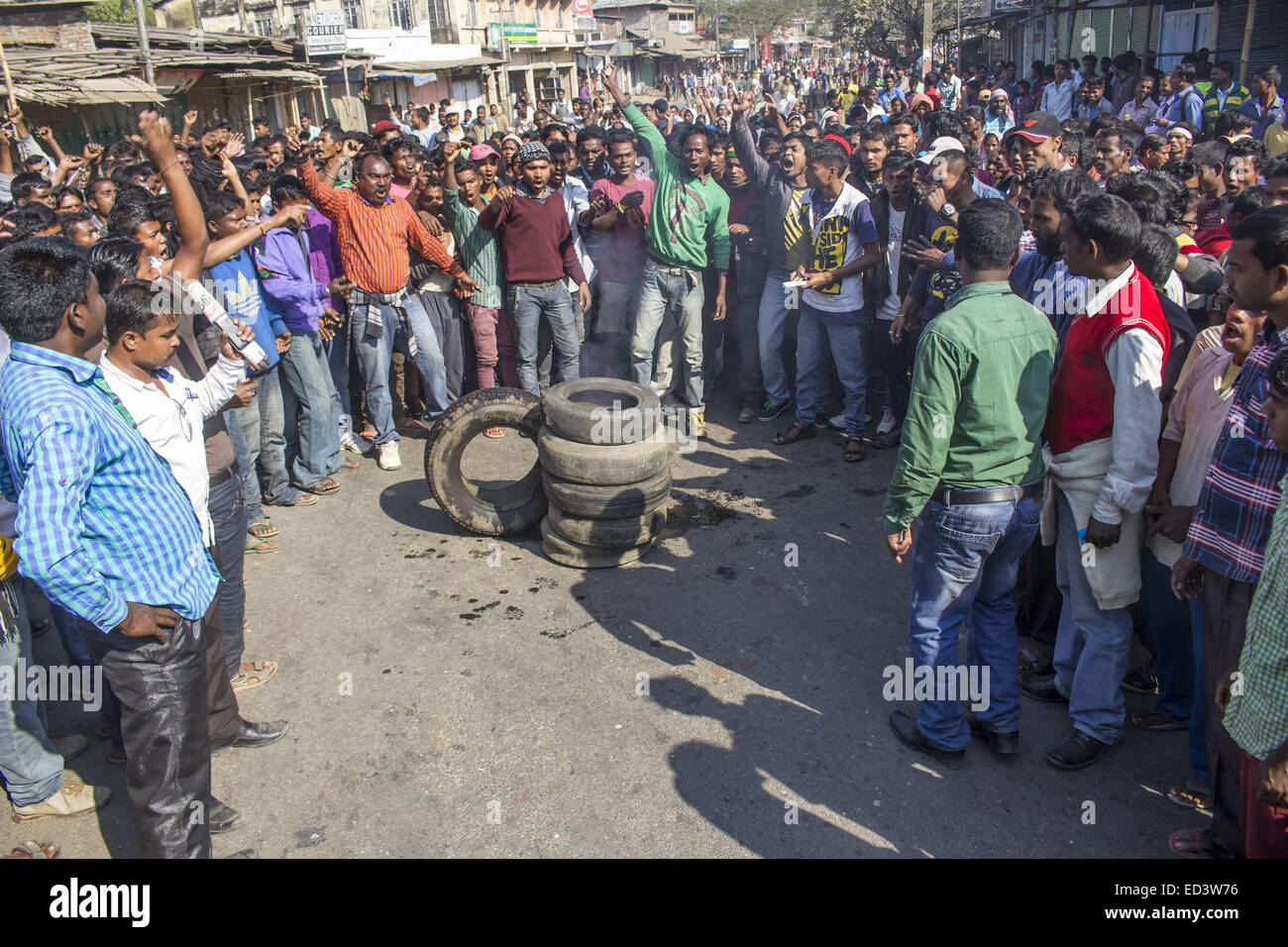 Demow, Assam, India. 26th Dec, 2014.Adivasi tribals burn tyres as they ...