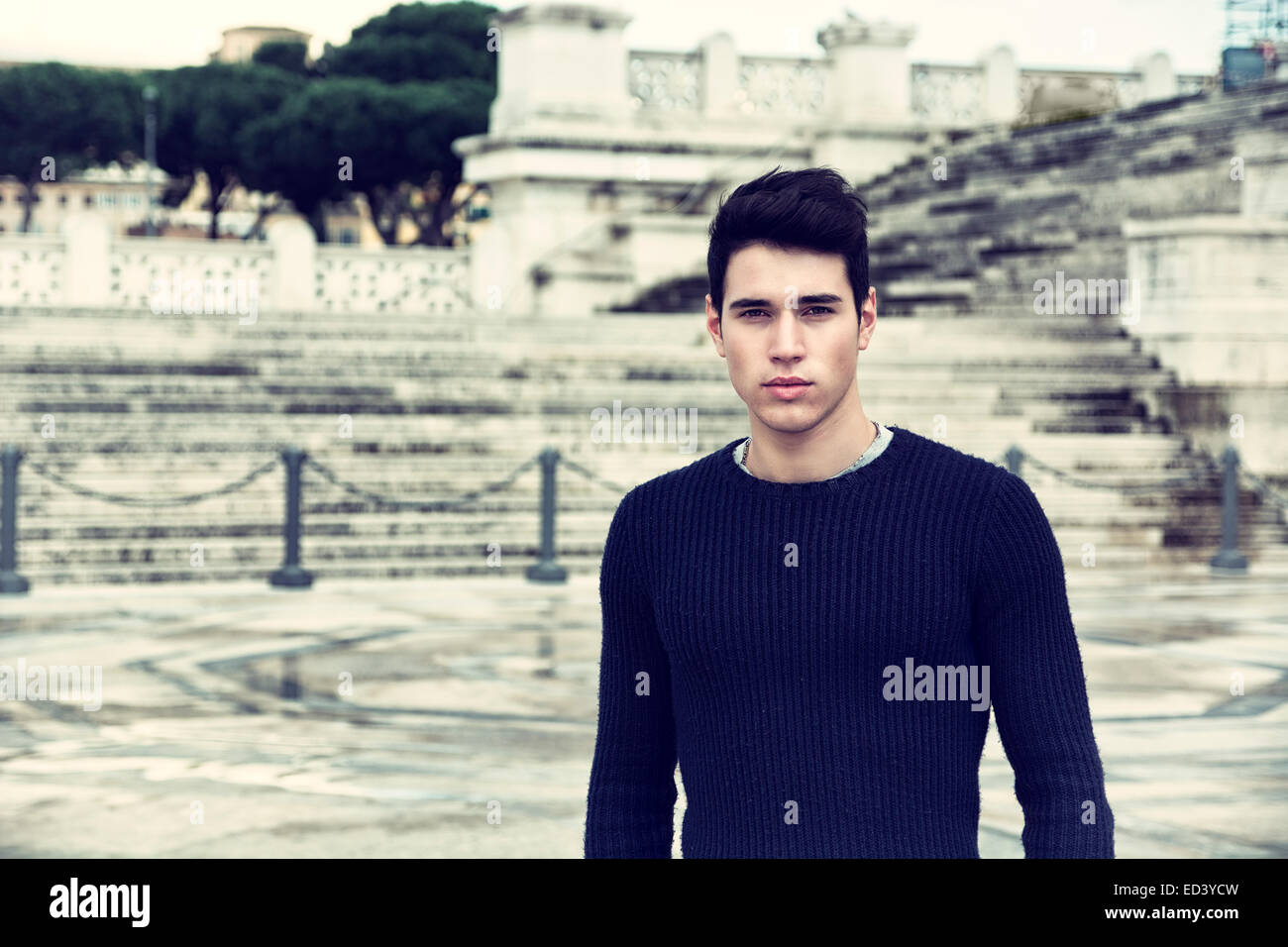 Attractive young man in Rome in front of Vittoriano monument standing ...