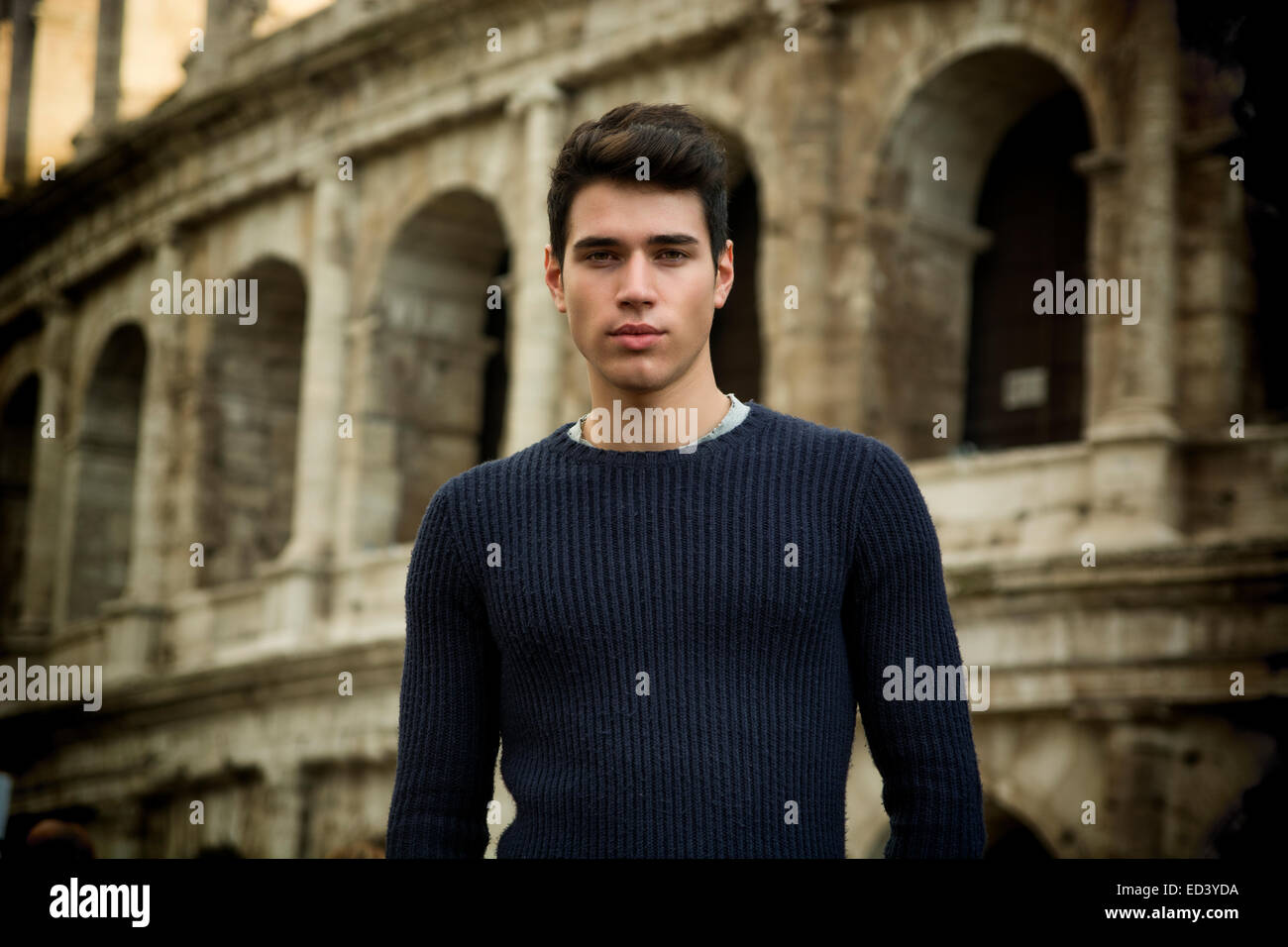 Attractive young man in Rome standing in front of the Colosseum ...