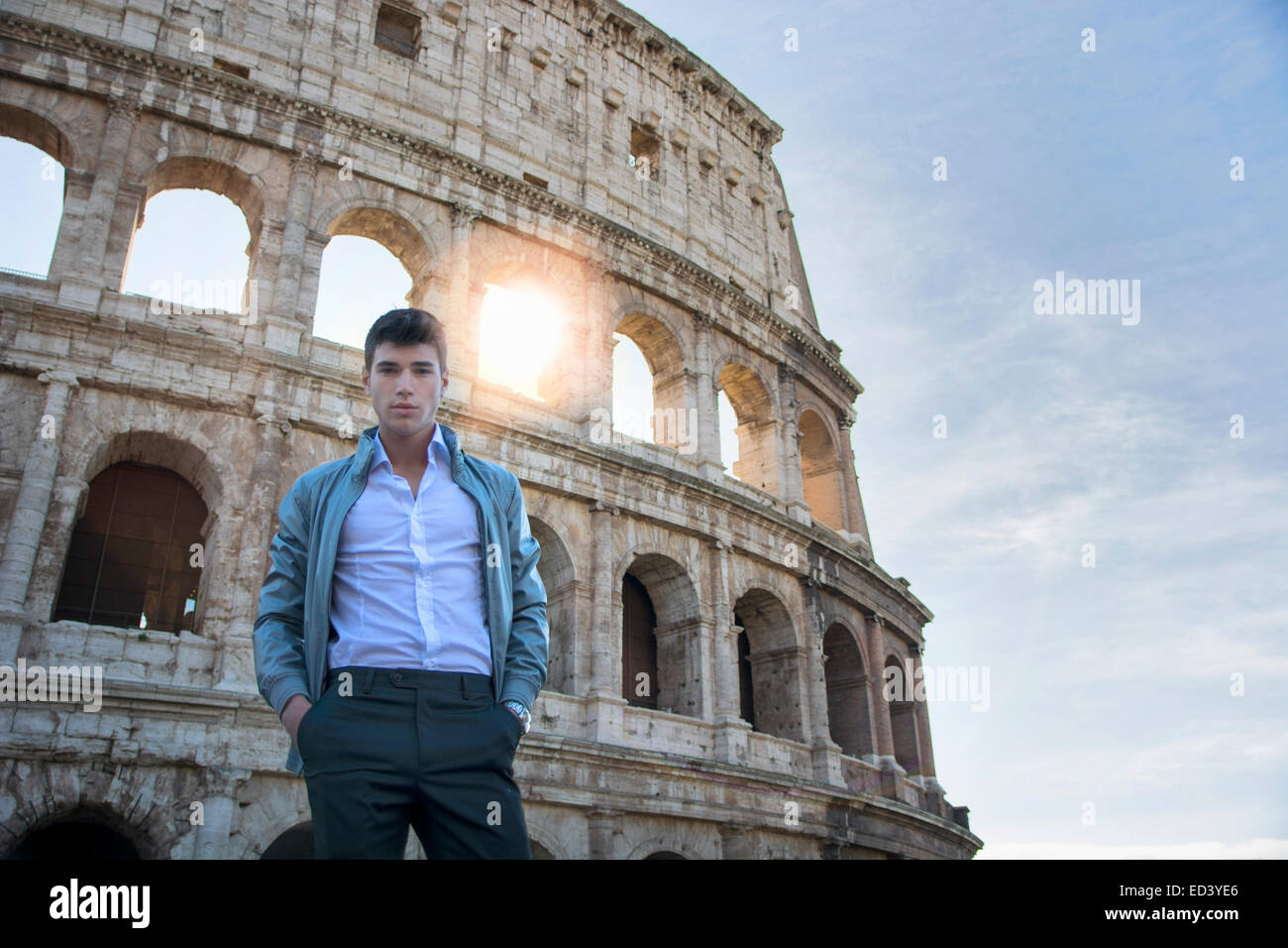Attractive young man in Rome standing in front of the Colosseum ...