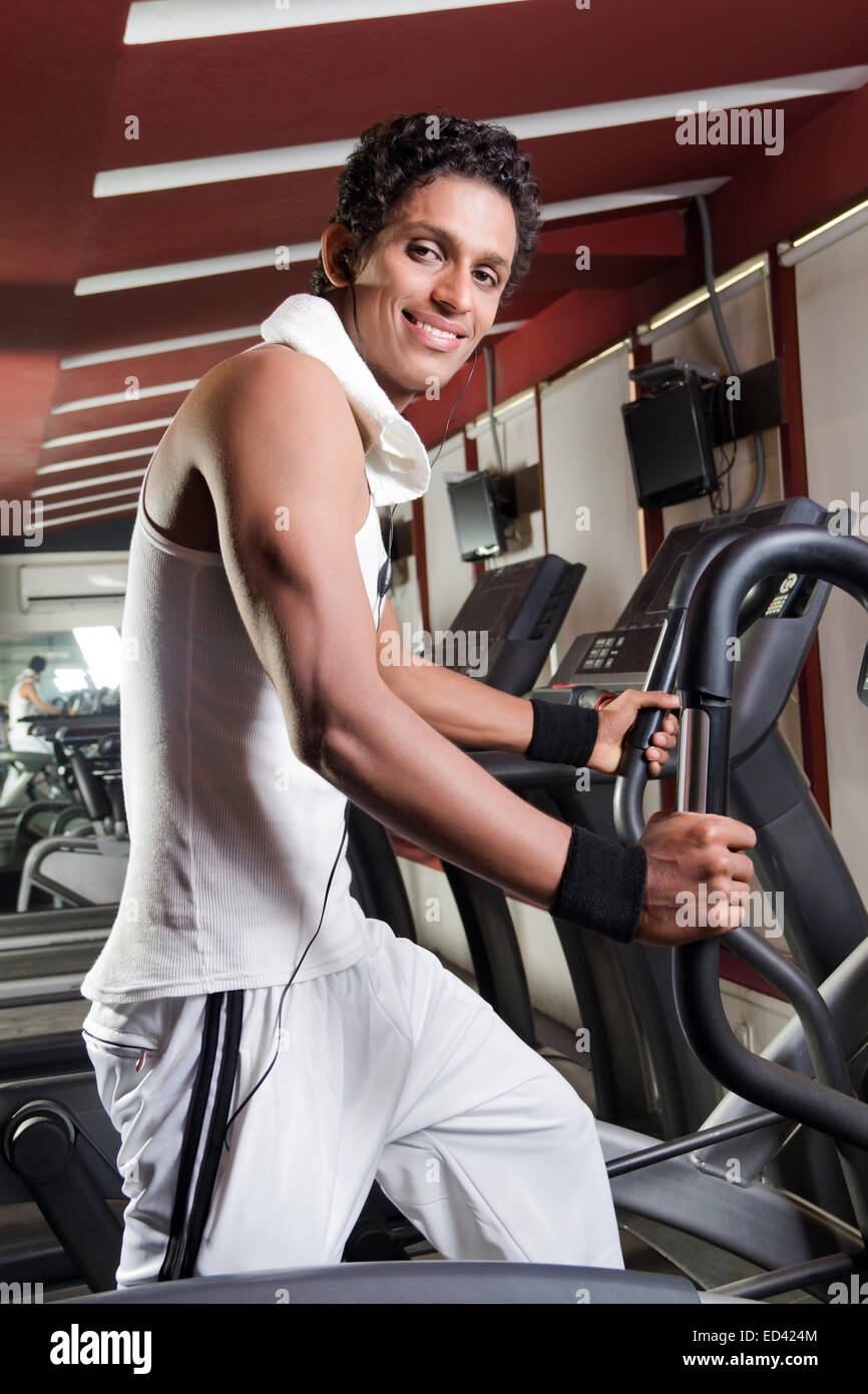 Indian man running on treadmill at gym hi-res stock photography and ...