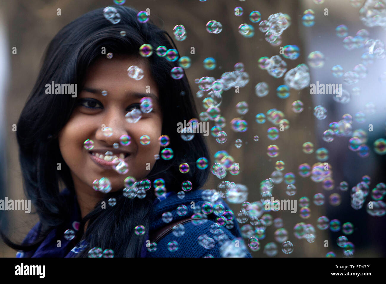 Dhaka, Bangladesh. 26th Dec, 2014. A teenage girl enjoying bubble play in a park in Dhaka ...