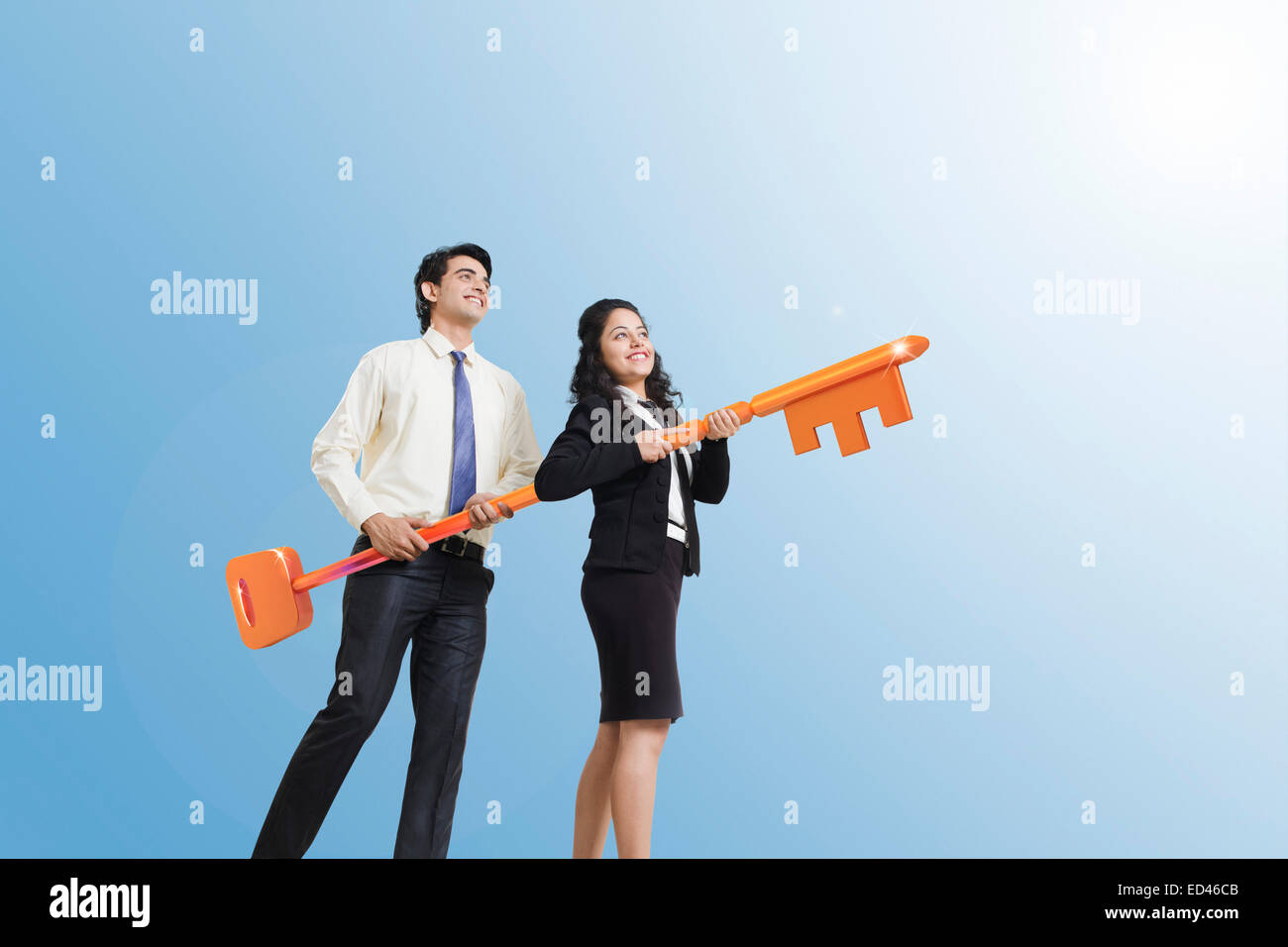 2 indian business people standing with key Stock Photo - Alamy