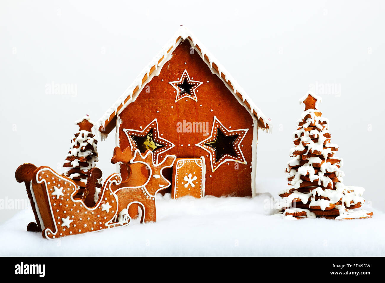 The hand-made eatable gingerbread house and New Year Trees with snow ...