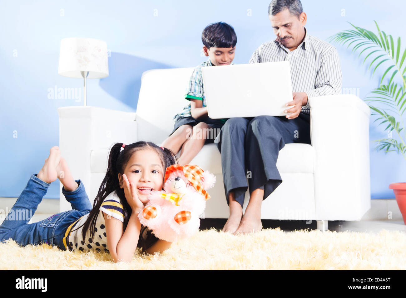indian father with children laptop watching Stock Photo - Alamy