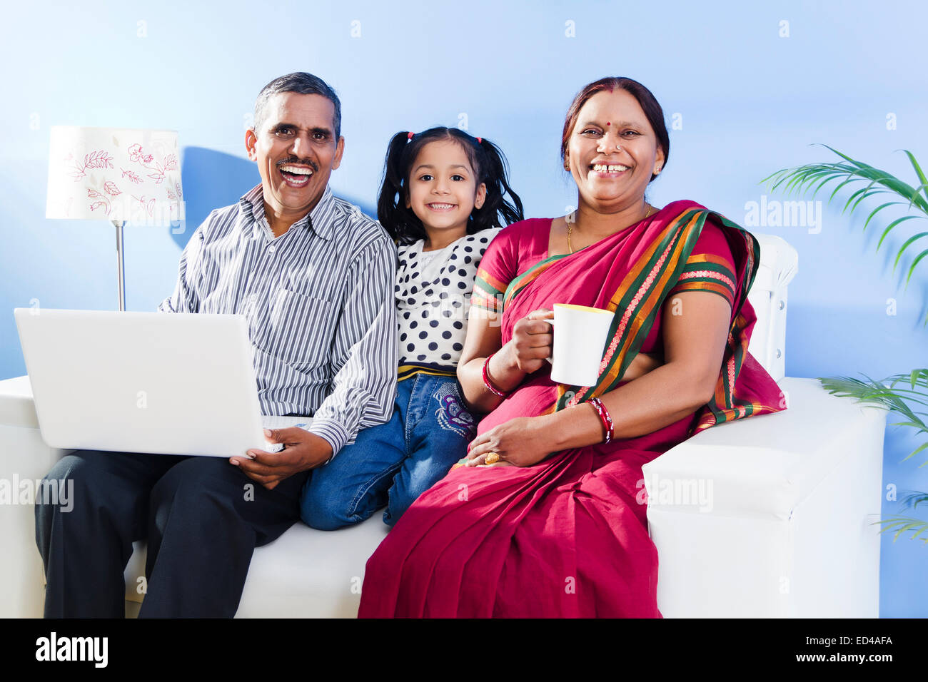 indian Parents with child laptop working Stock Photo - Alamy