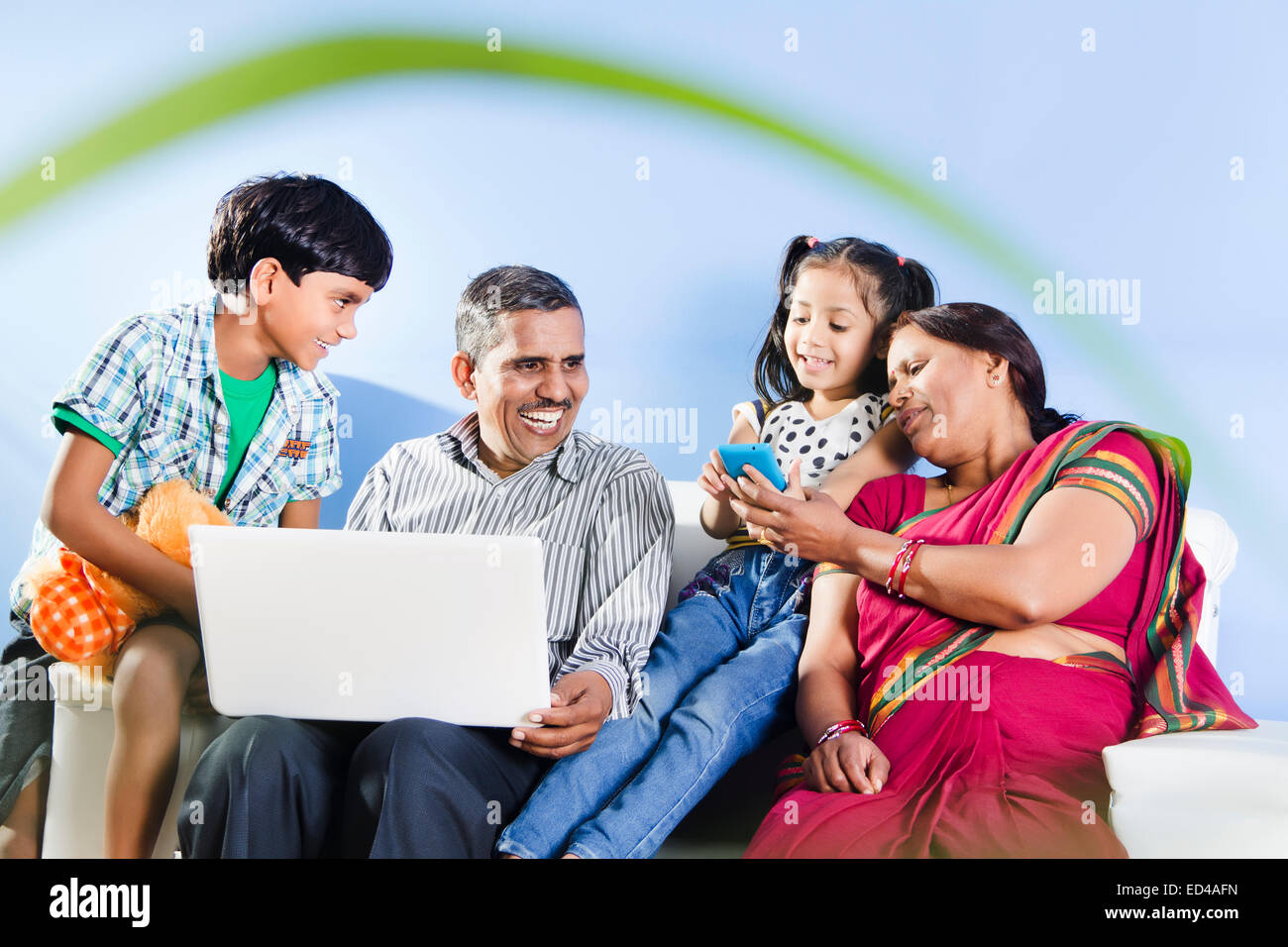 indian Parents with children laptop working Stock Photo - Alamy