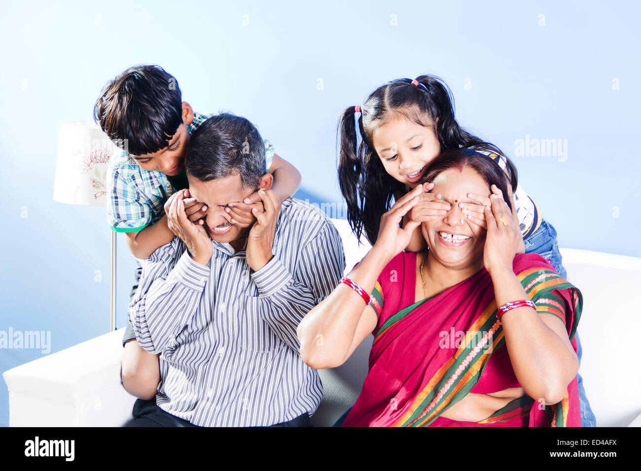 indian Parents with children home Mischief Stock Photo - Alamy