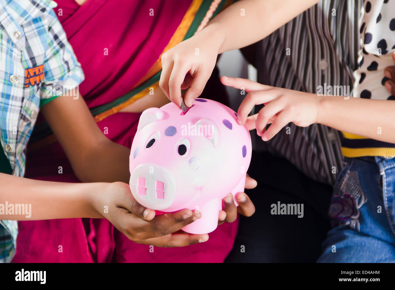 indian Parents with children saving money Piggy Bank Stock Photo - Alamy
