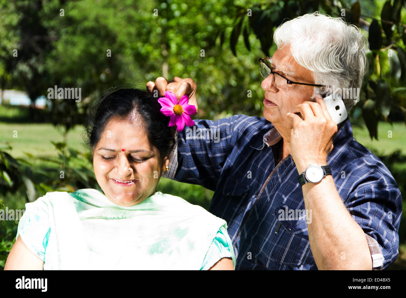 indian Old married couple park talking phone Stock Photo - Alamy