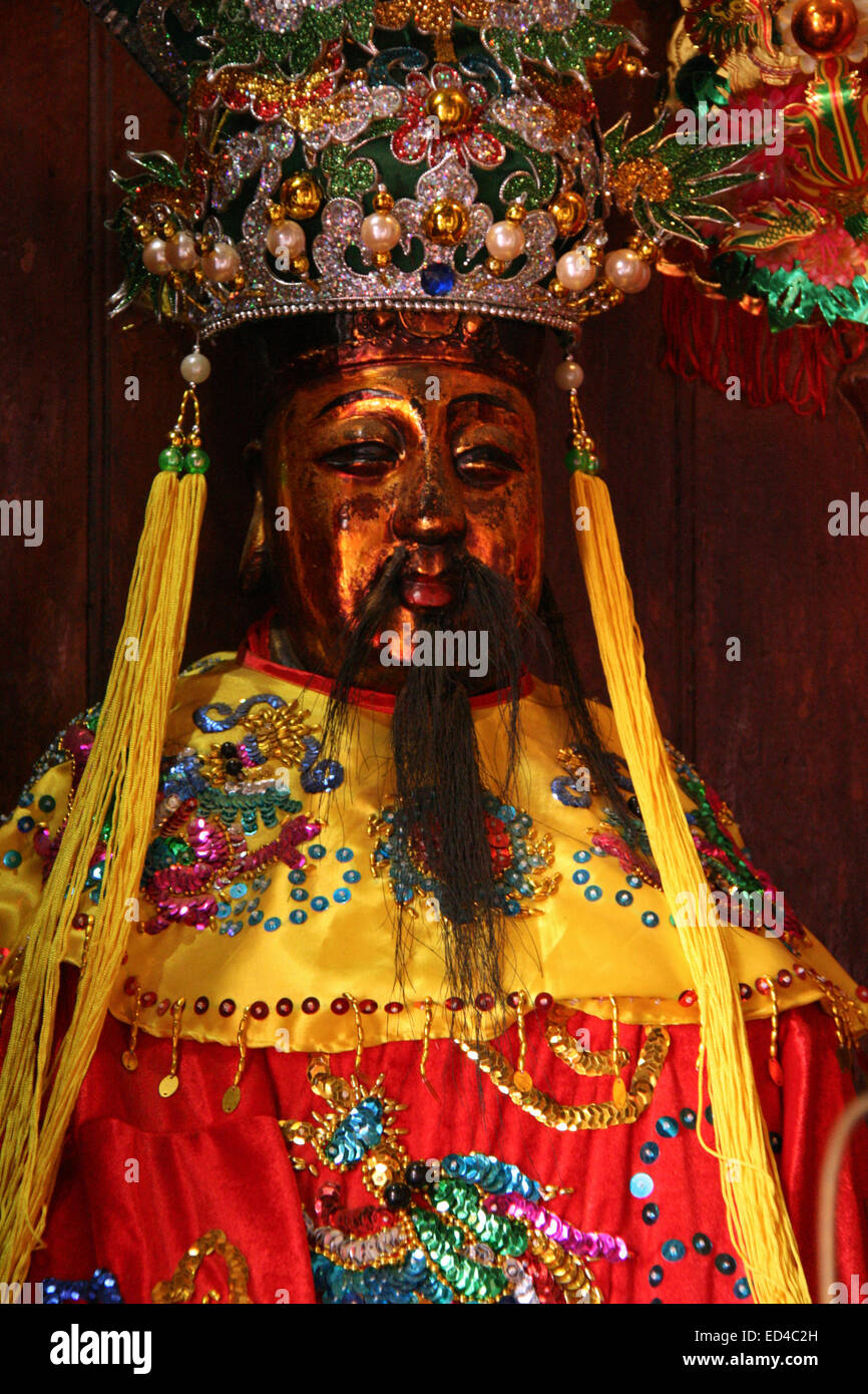 The statue of a divinity decorates one of the halls of a Buddhist ...