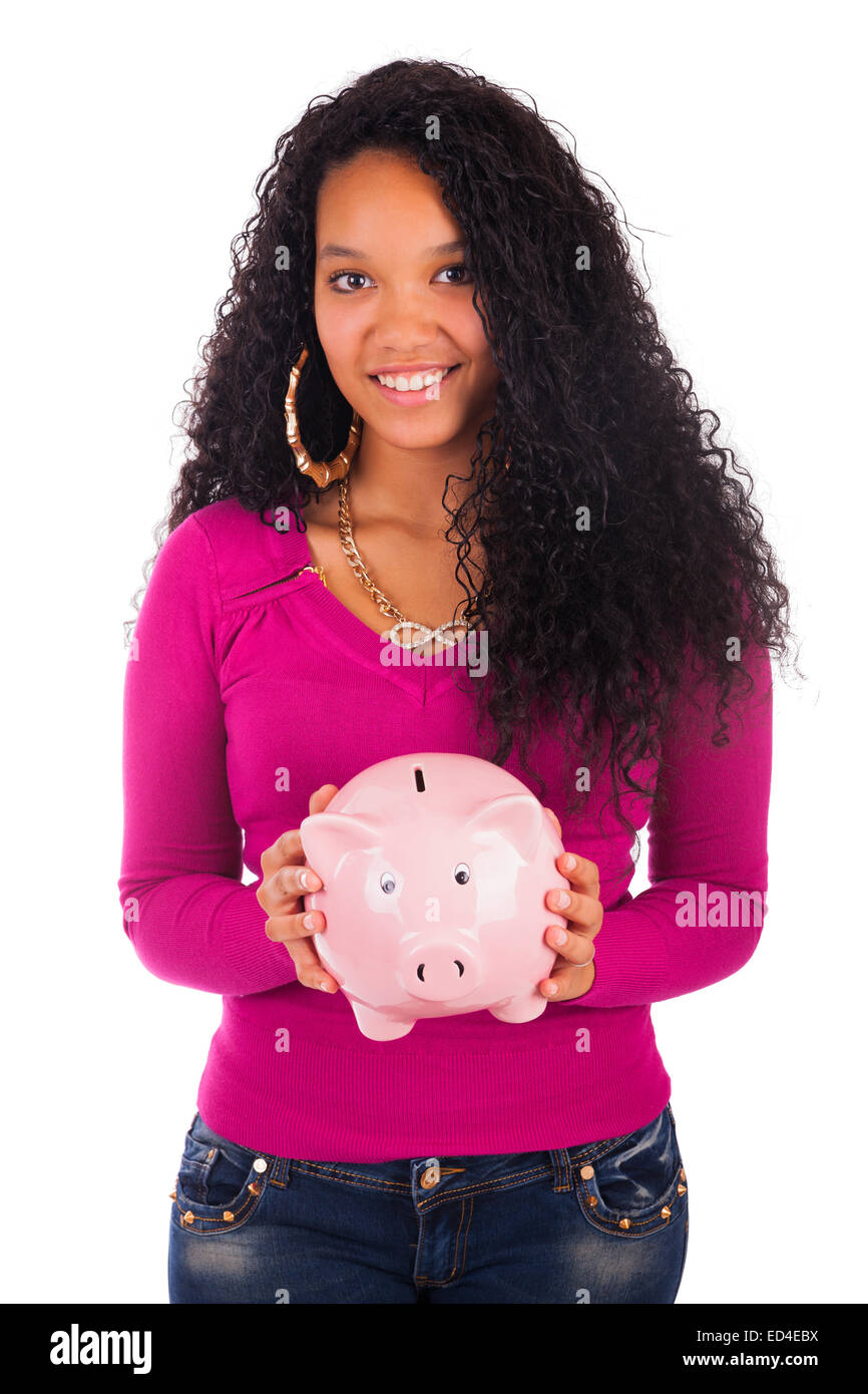 Young african american woman putting coin in piggy bank isolated Stock ...
