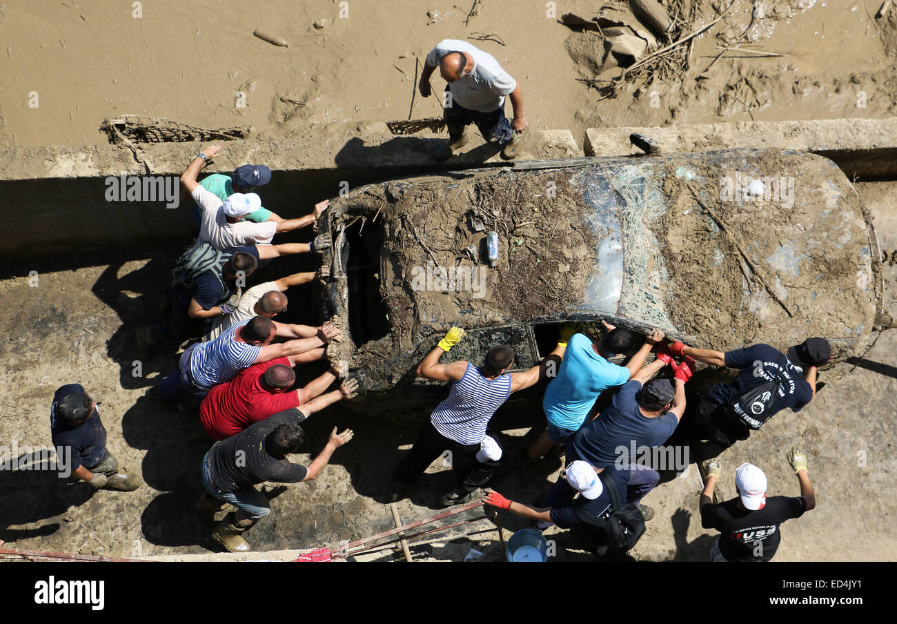 People and rescue workers try to salvage what they can from the ...