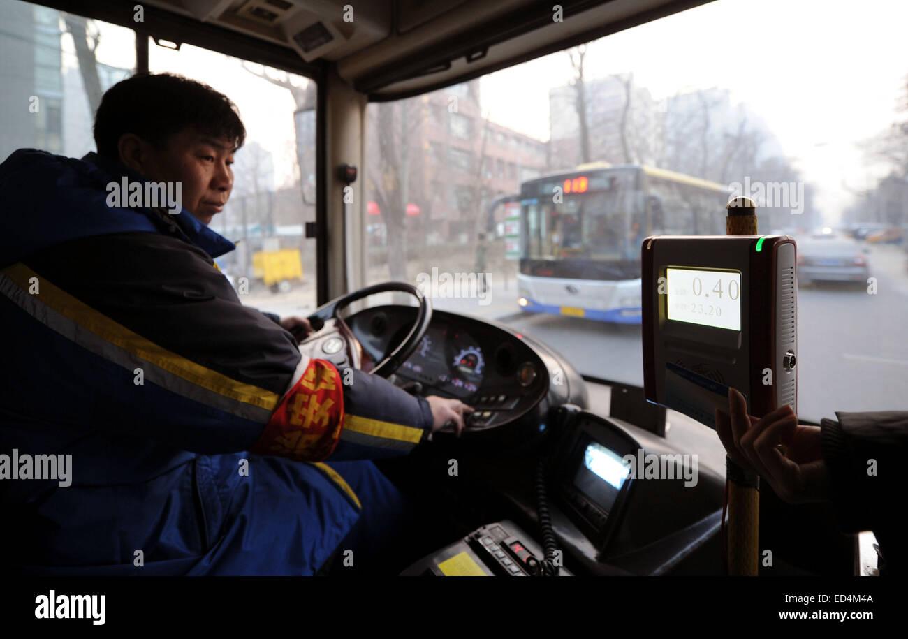 (141227) -- BEIJING, Dec. 27, 2014 (Xinhua) -- A bus driver watches ...