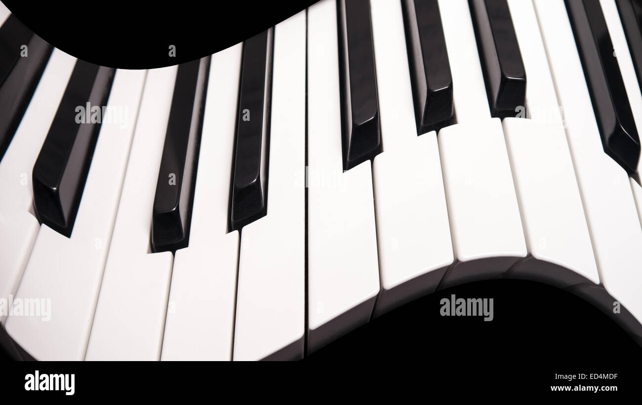 curved piano keys, abstract photo with black background Stock Photo - Alamy