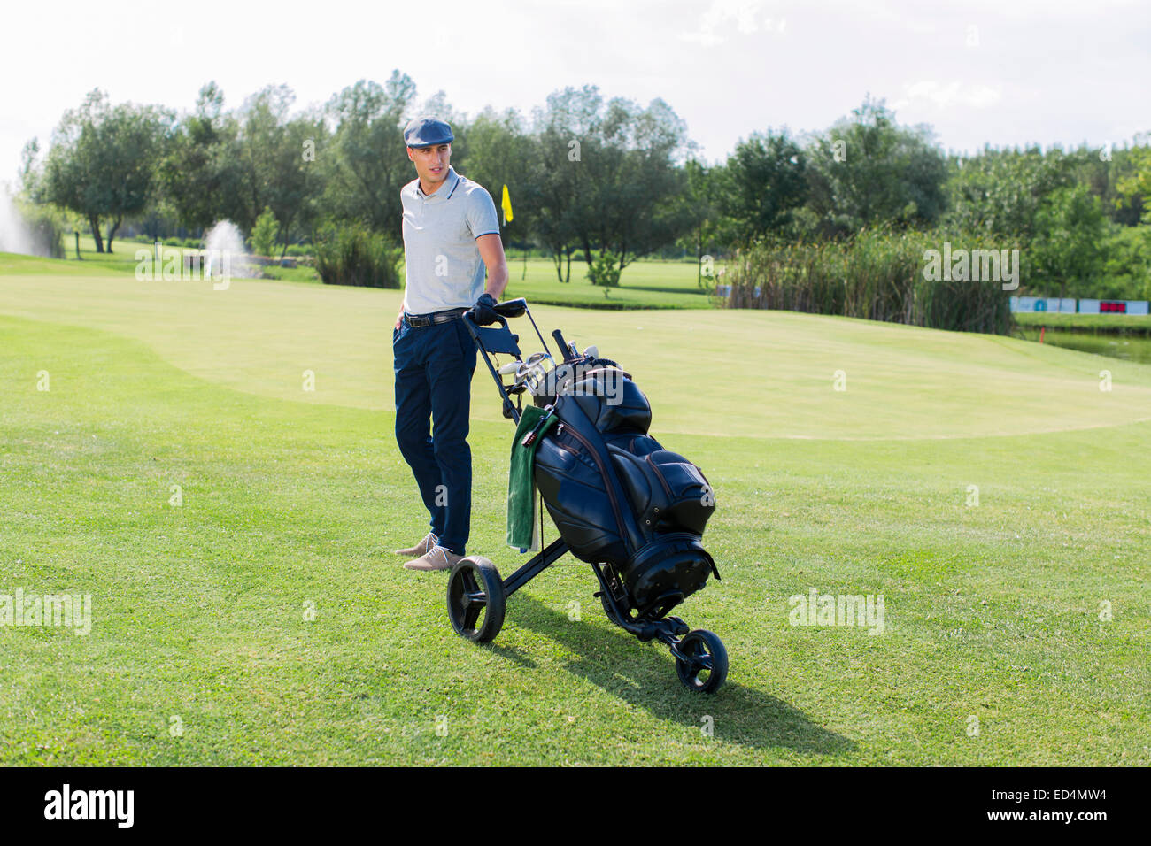 Young man playing golf Stock Photo - Alamy