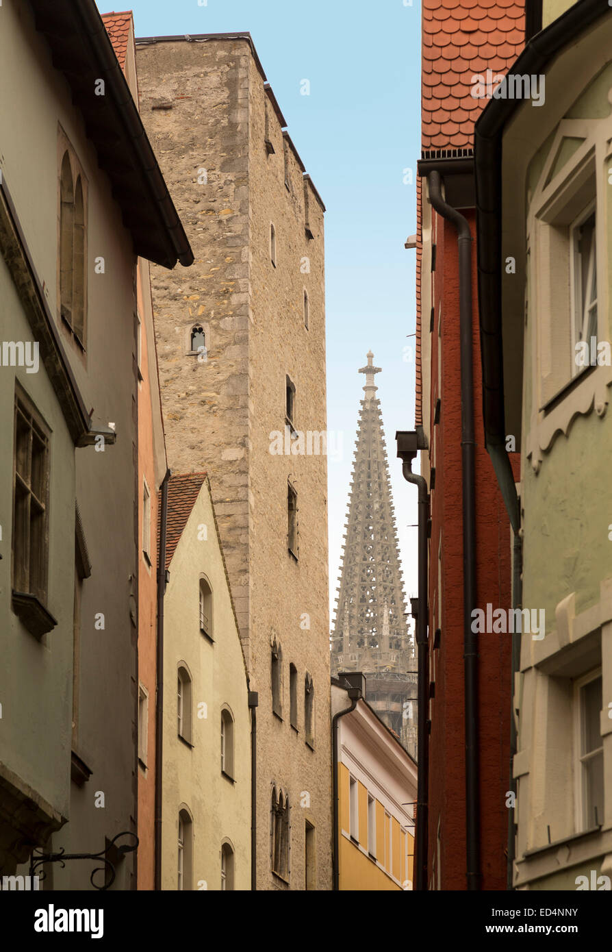 Cathedral tower and spire in distance along narrow street in the ...