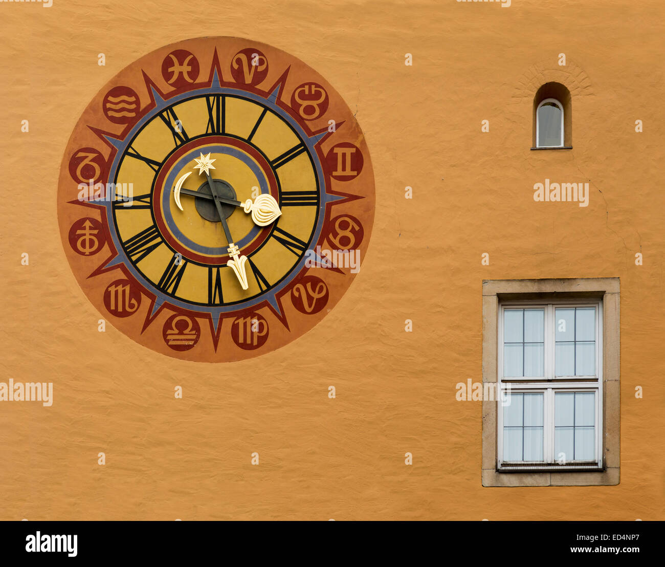 Ancient clock face on wall in the medieval town of Regensburg, Bavaria ...