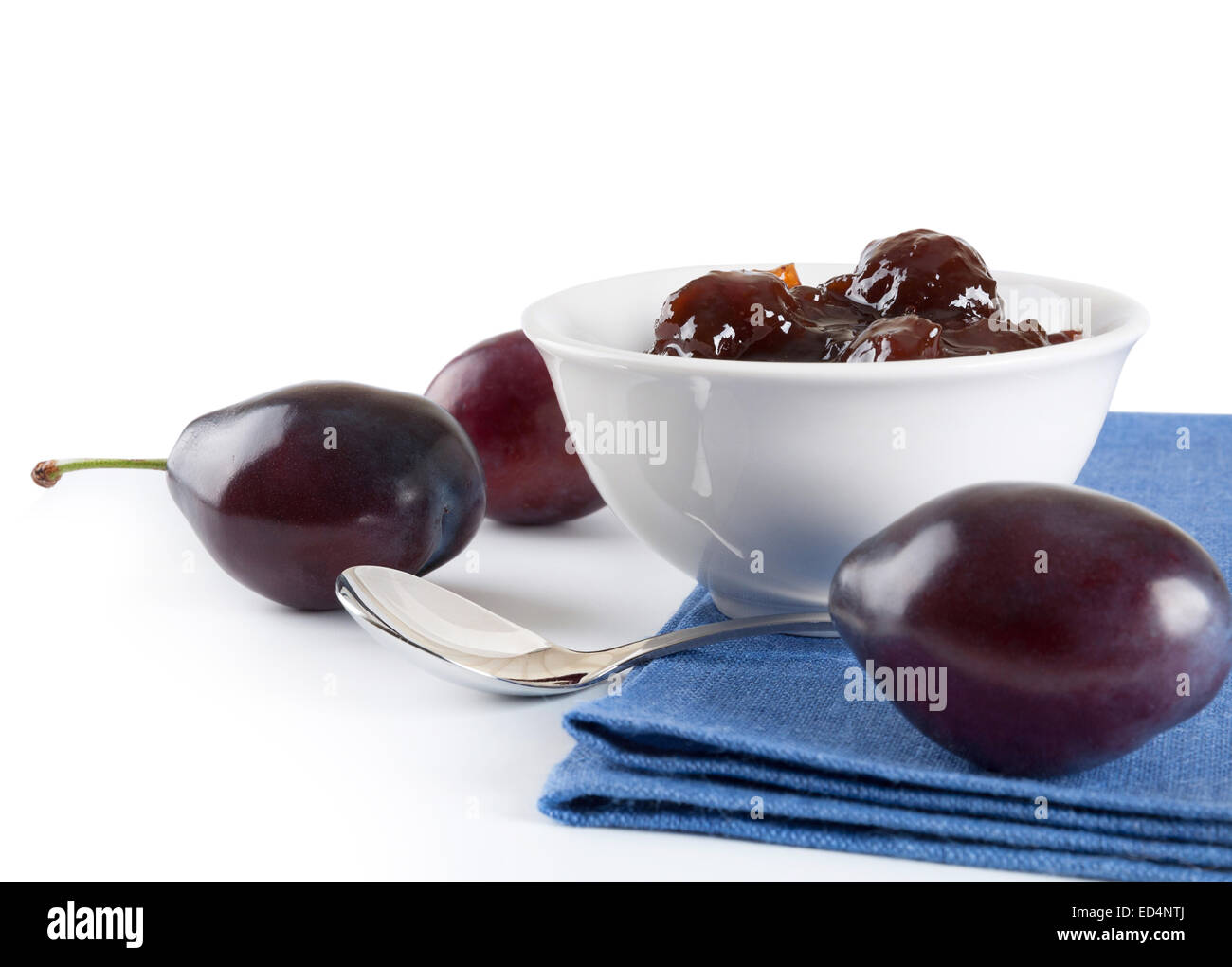Ripe plums, jam and spoon on white background Stock Photo - Alamy