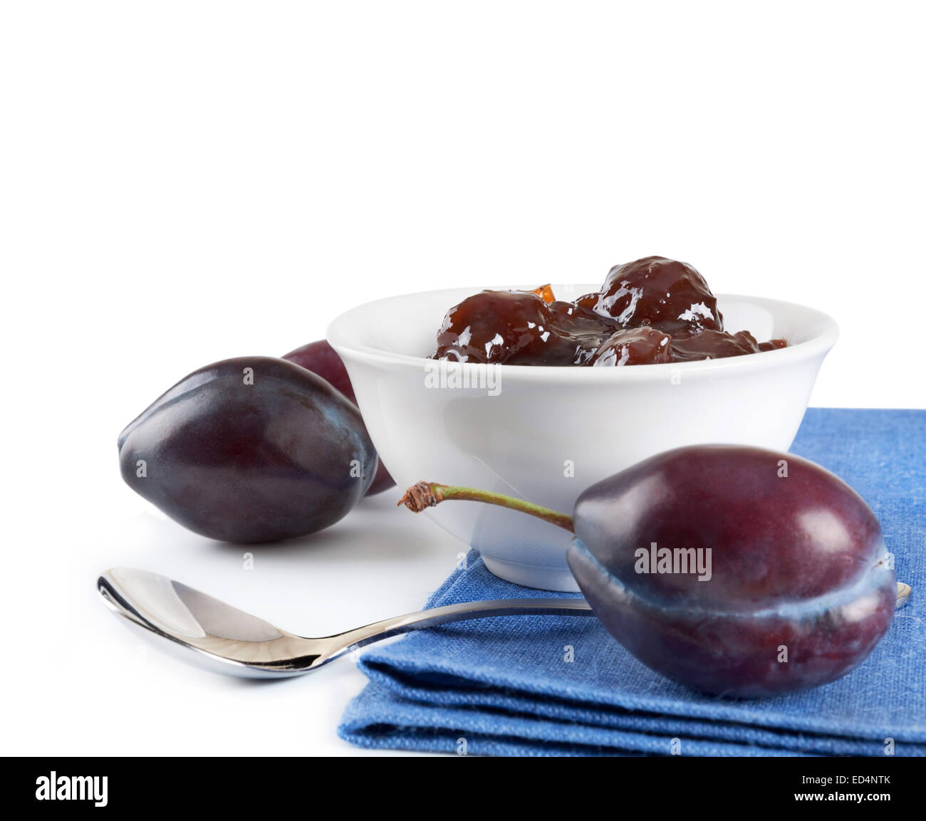 Ripe plums, jam and spoon on white background Stock Photo - Alamy