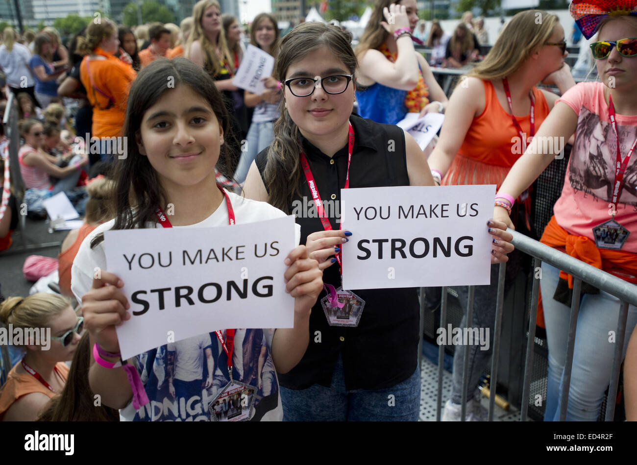 Fans of boyband One Direction gather in large numbers and show their ...