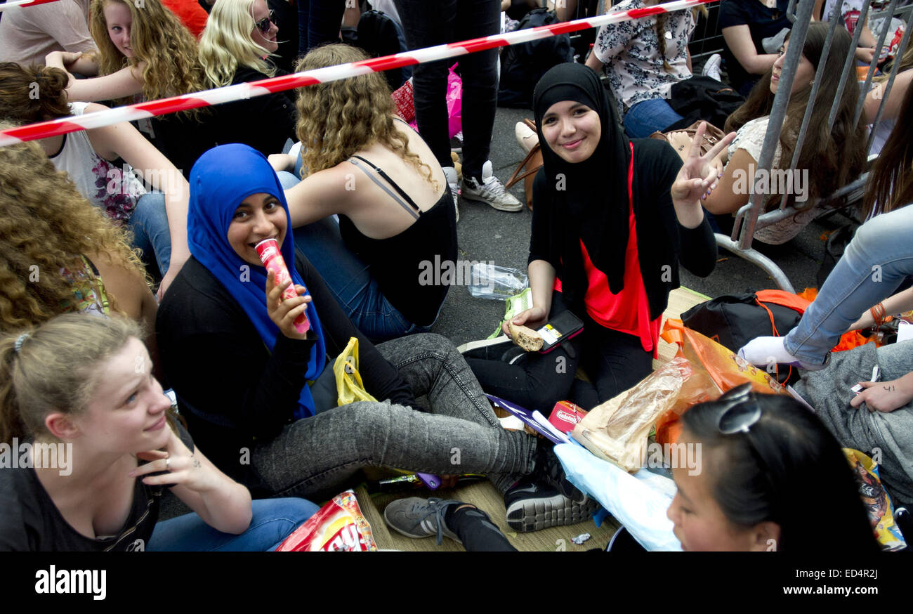 Fans of boyband One Direction gather in large numbers and show their ...