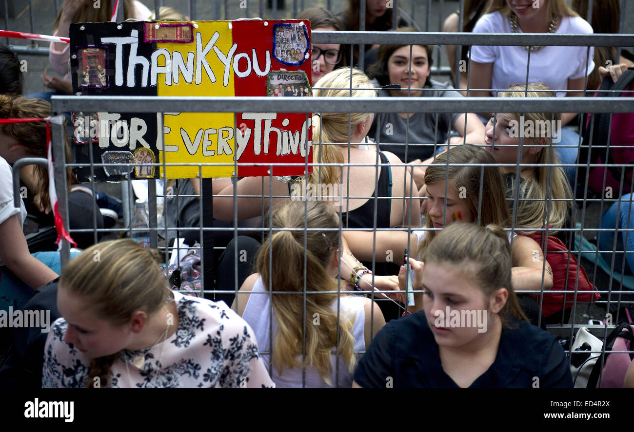 Fans of boyband One Direction gather in large numbers and show their ...