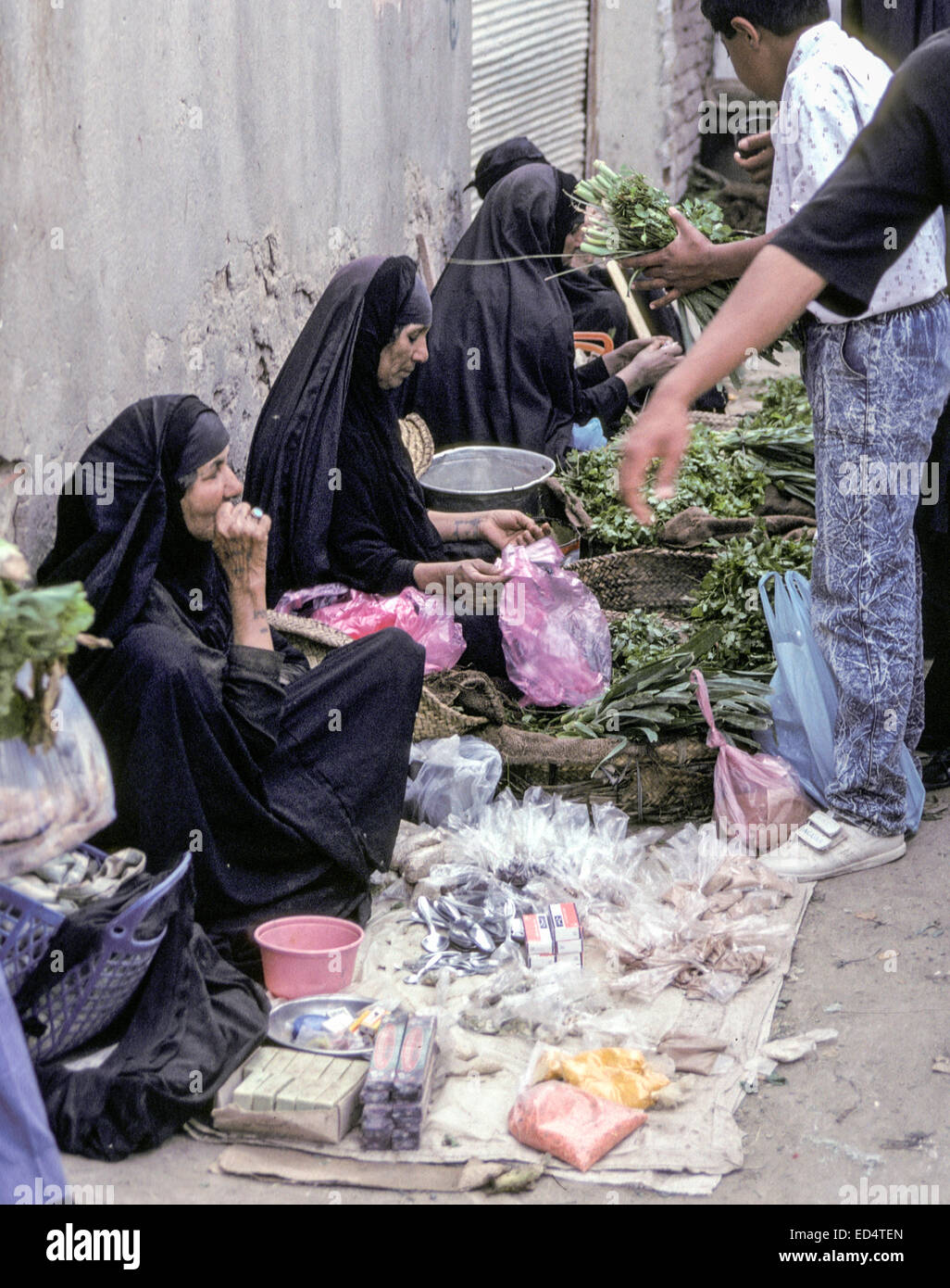 Iraqi women selling vegetables and household goods on the street in ...
