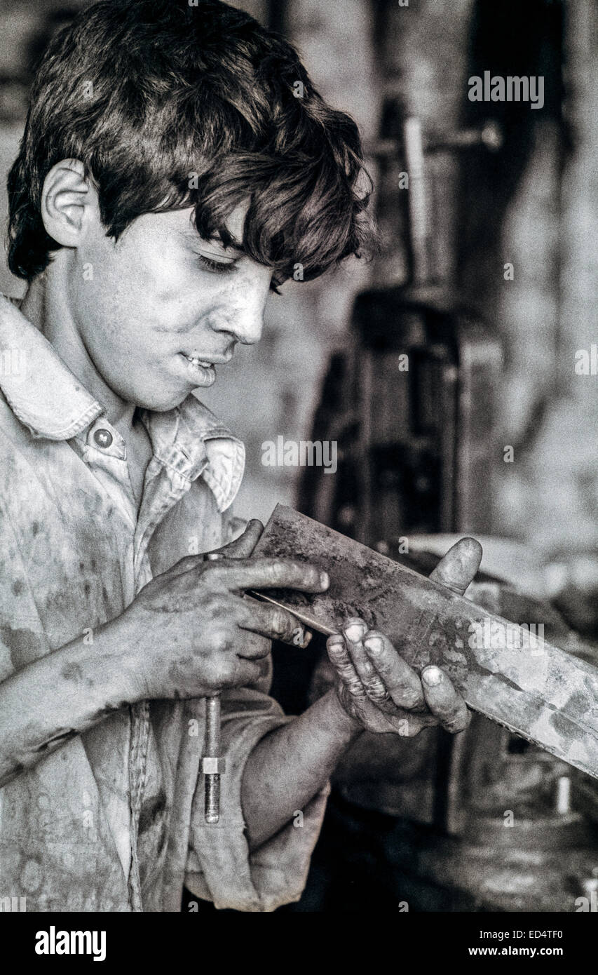 Young Iraqi boy who works in a garage to support his family after his ...