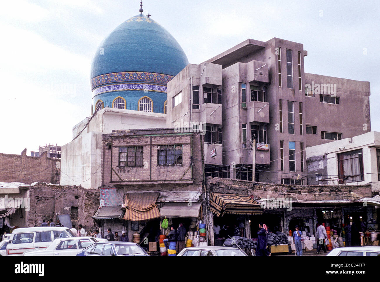 Downtown Baghdad with traffic, people, entrance to souk and blue-tiled ...