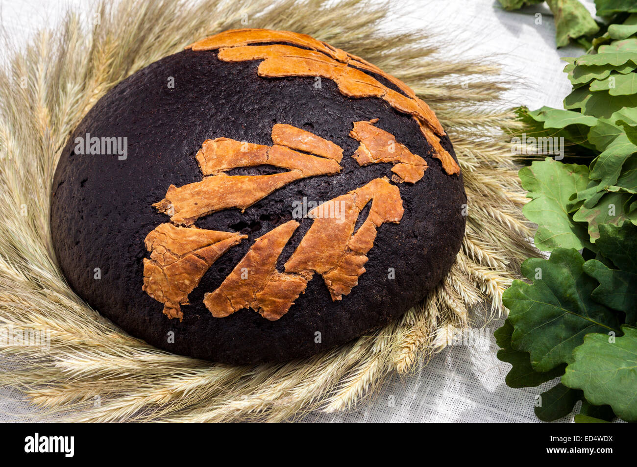 Traditional Lithuanian brown bread decorated with rye and oak leaves ...