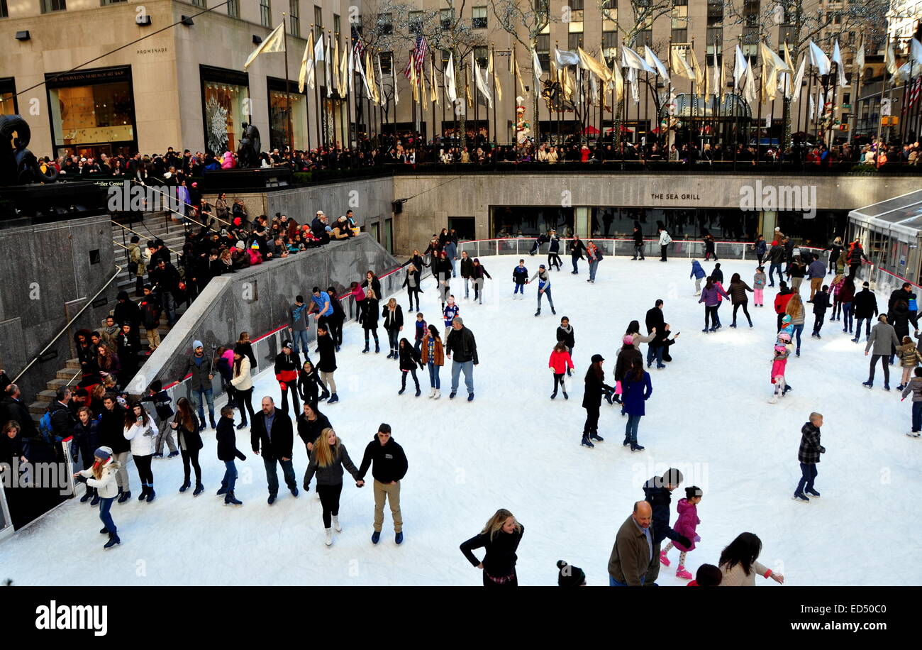 New York City: Skaters at the Rockefeller Center ice rink surrounded by ...