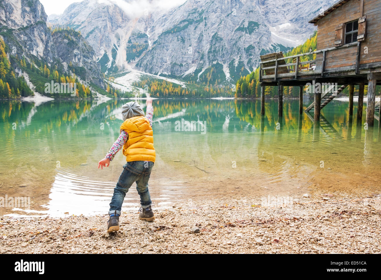 Child throwing stones in water hi-res stock photography and images - Alamy