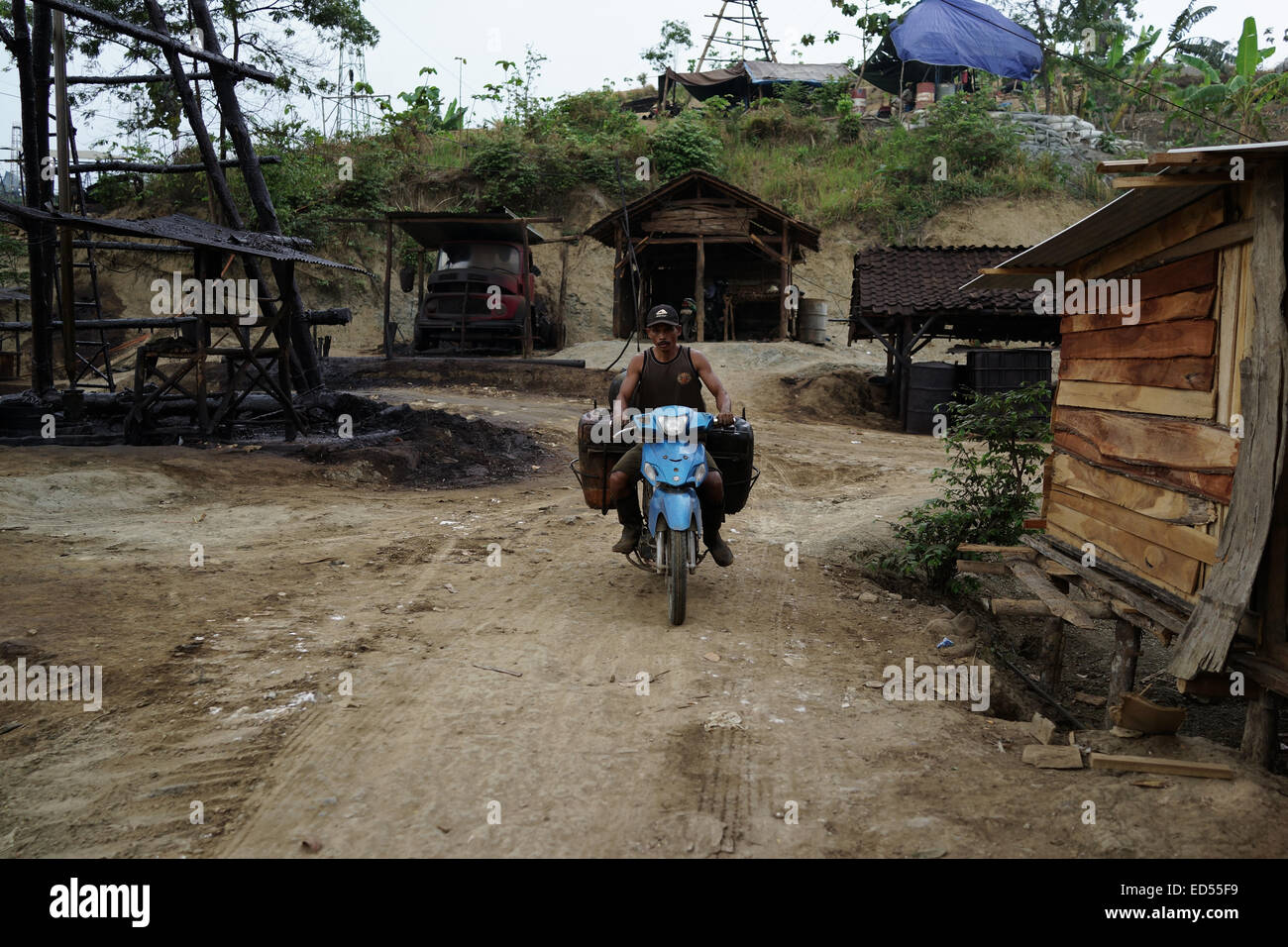 Men on motorcycles transport refined diesel fuel to be sold in ...