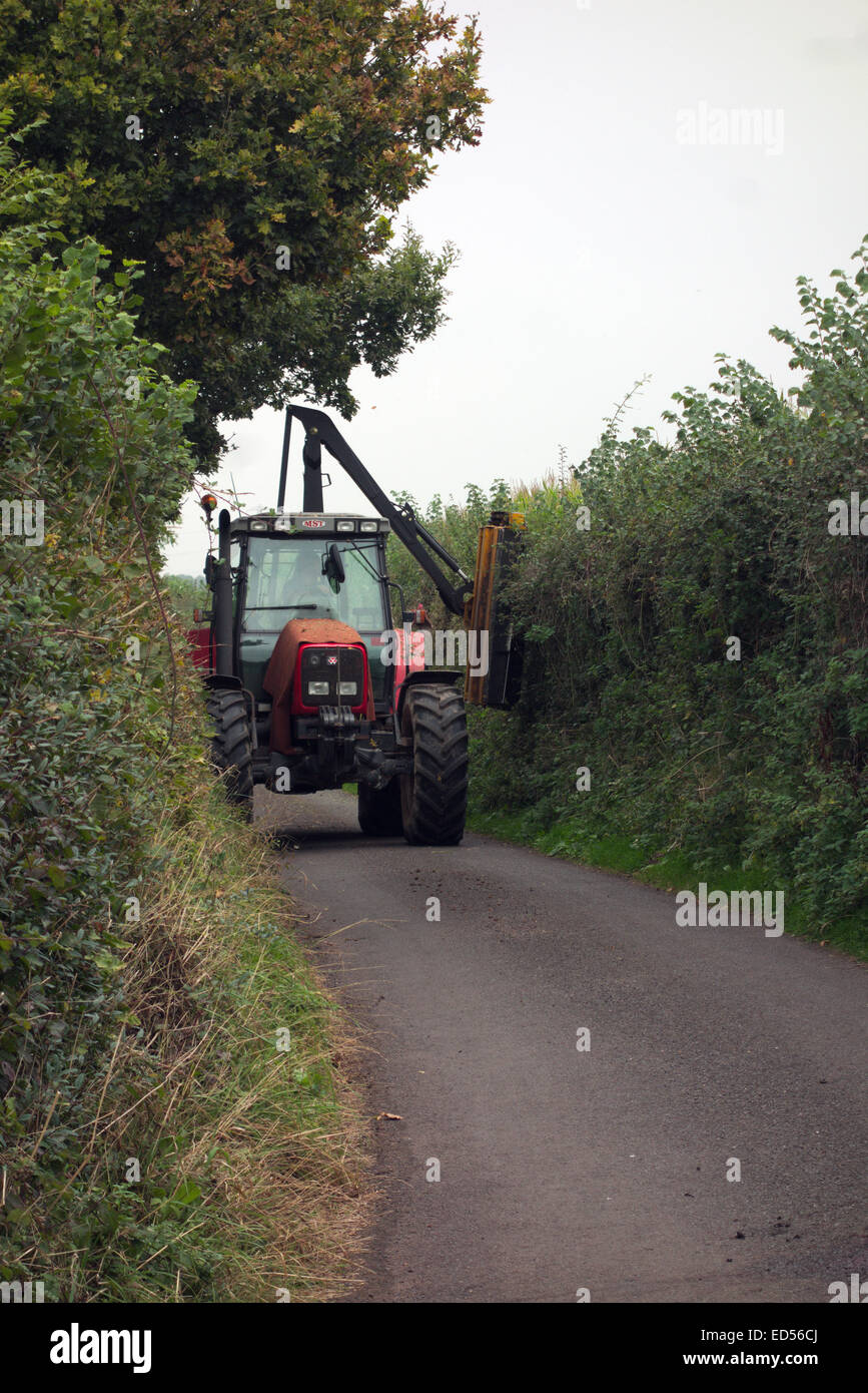 Hedge trimming with a tractor mounted flail mower, a Somerset lane, UK ...