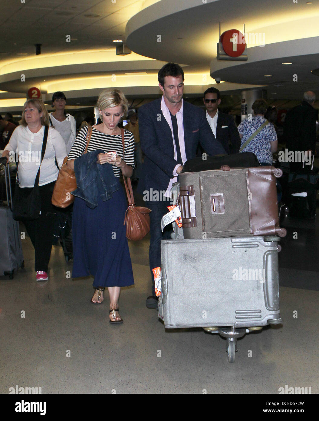 Noah Wyle and Sara Wells arrive at Los Angeles International Airport ...