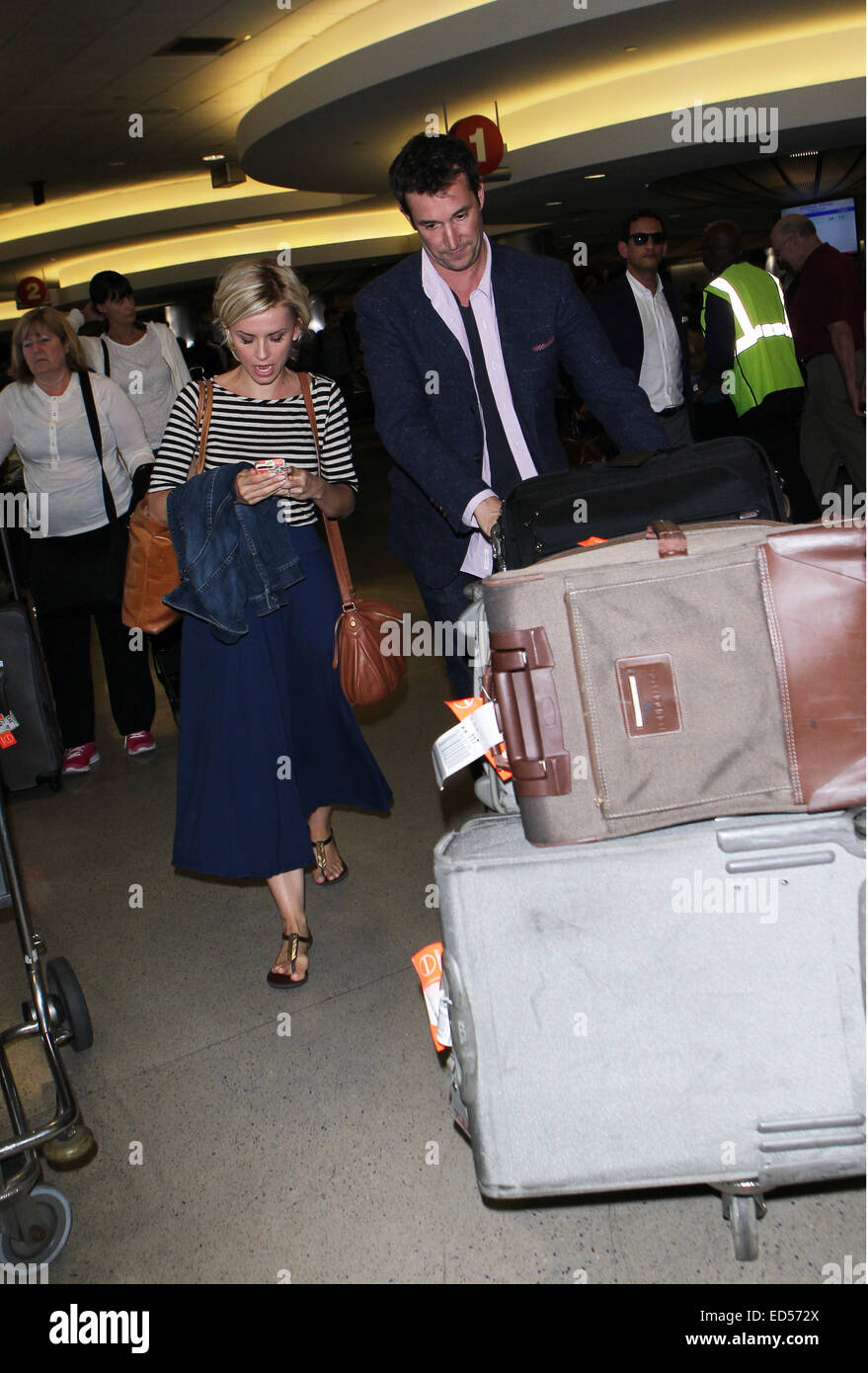 Noah Wyle and Sara Wells arrive at Los Angeles International Airport ...