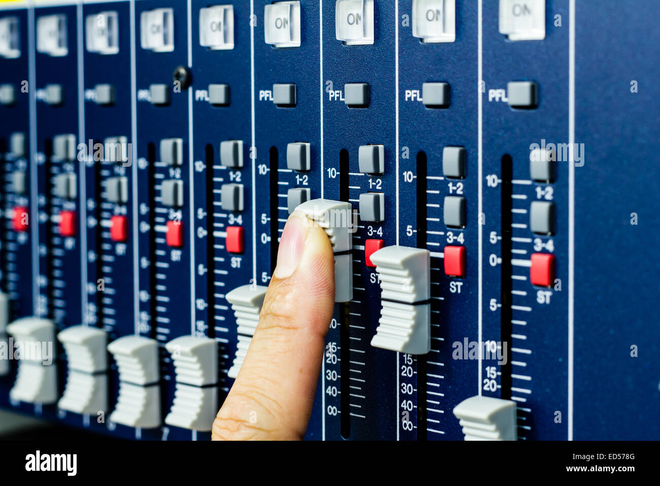 Hand pushing open a fader on a sound desk Stock Photo - Alamy