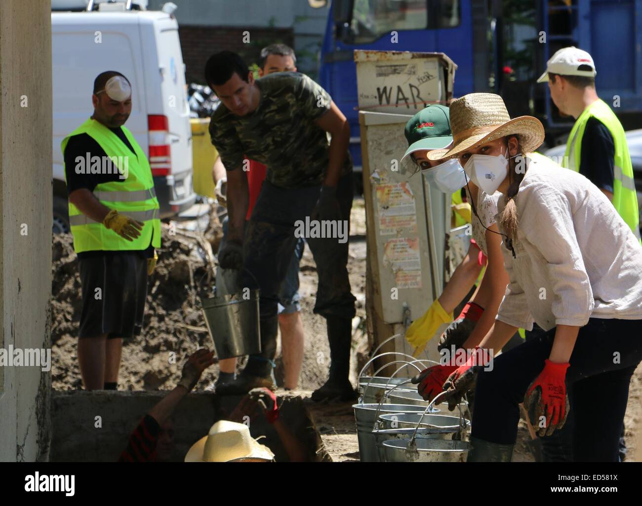 People and rescue workers try to salvage what they can from the ...