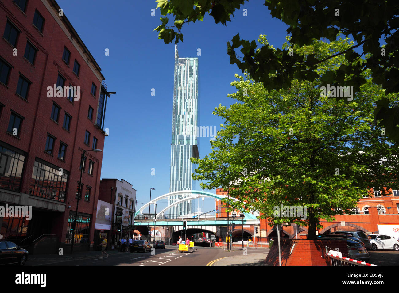 A city road with a railway bridge and a modern tower block in the ...