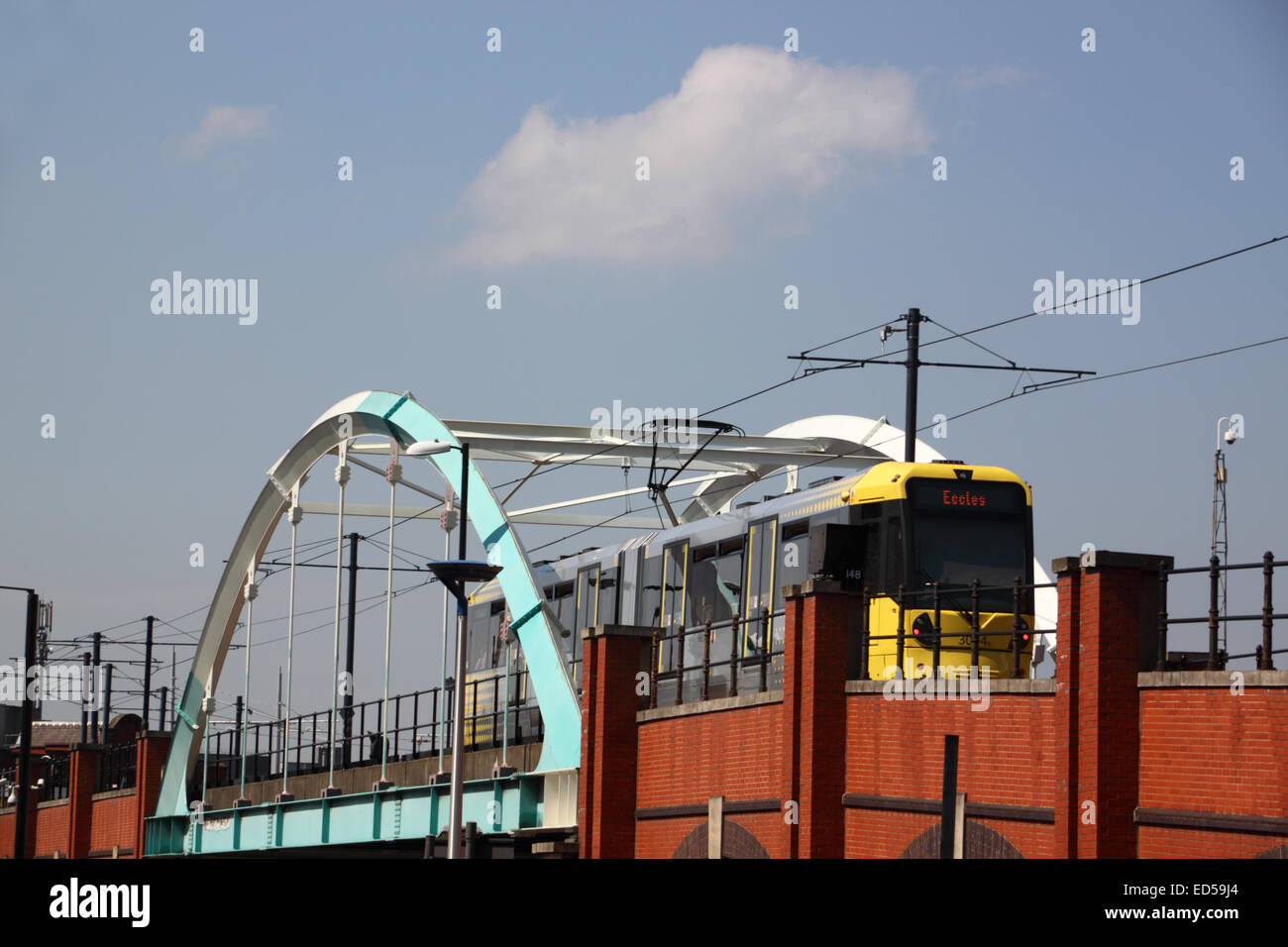 A yellow Metro Link tram crossing an iron bridge over Great Bridgewater ...