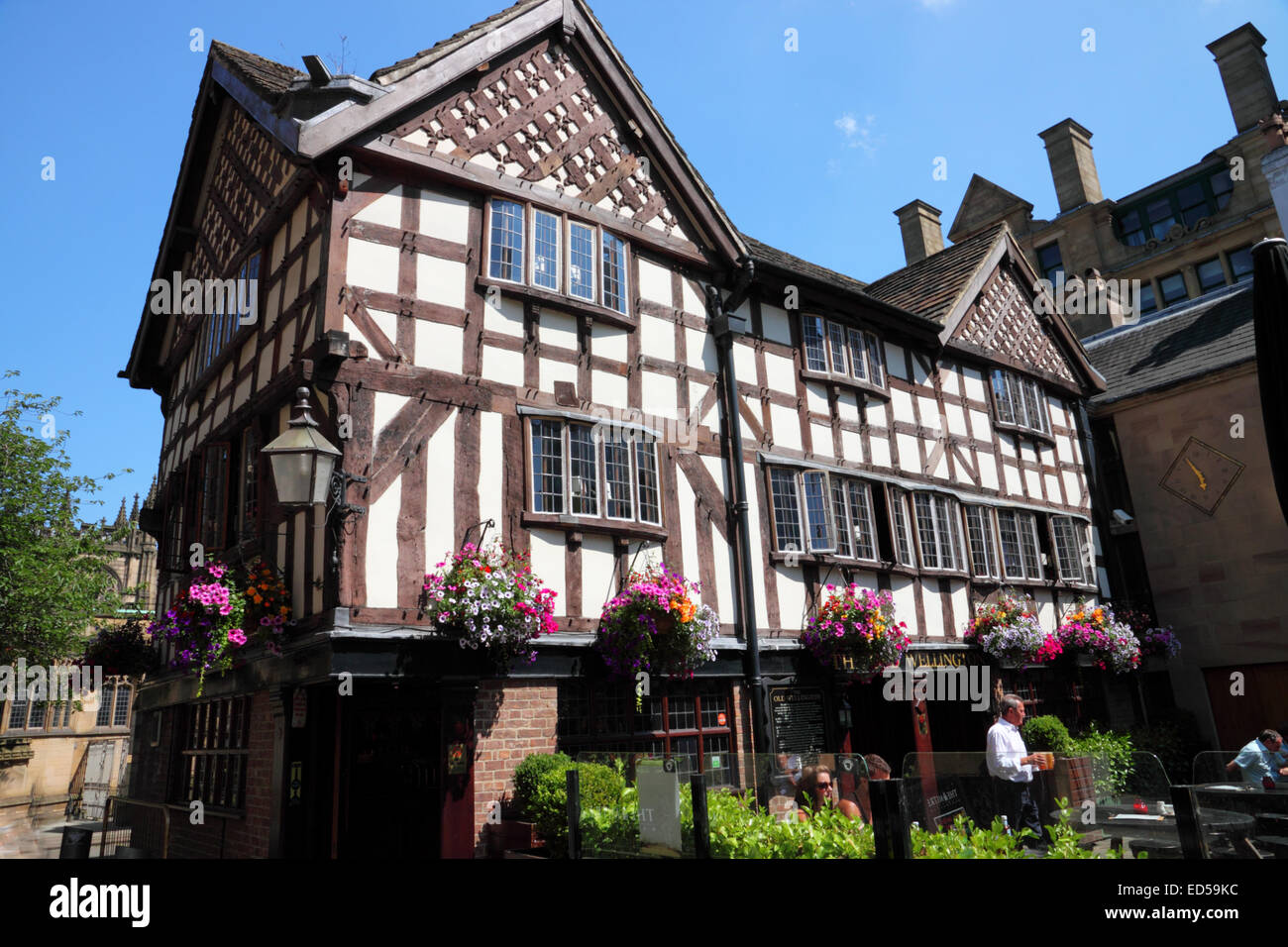 A half-timbered 'pub with hanging flower baskets Stock Photo - Alamy