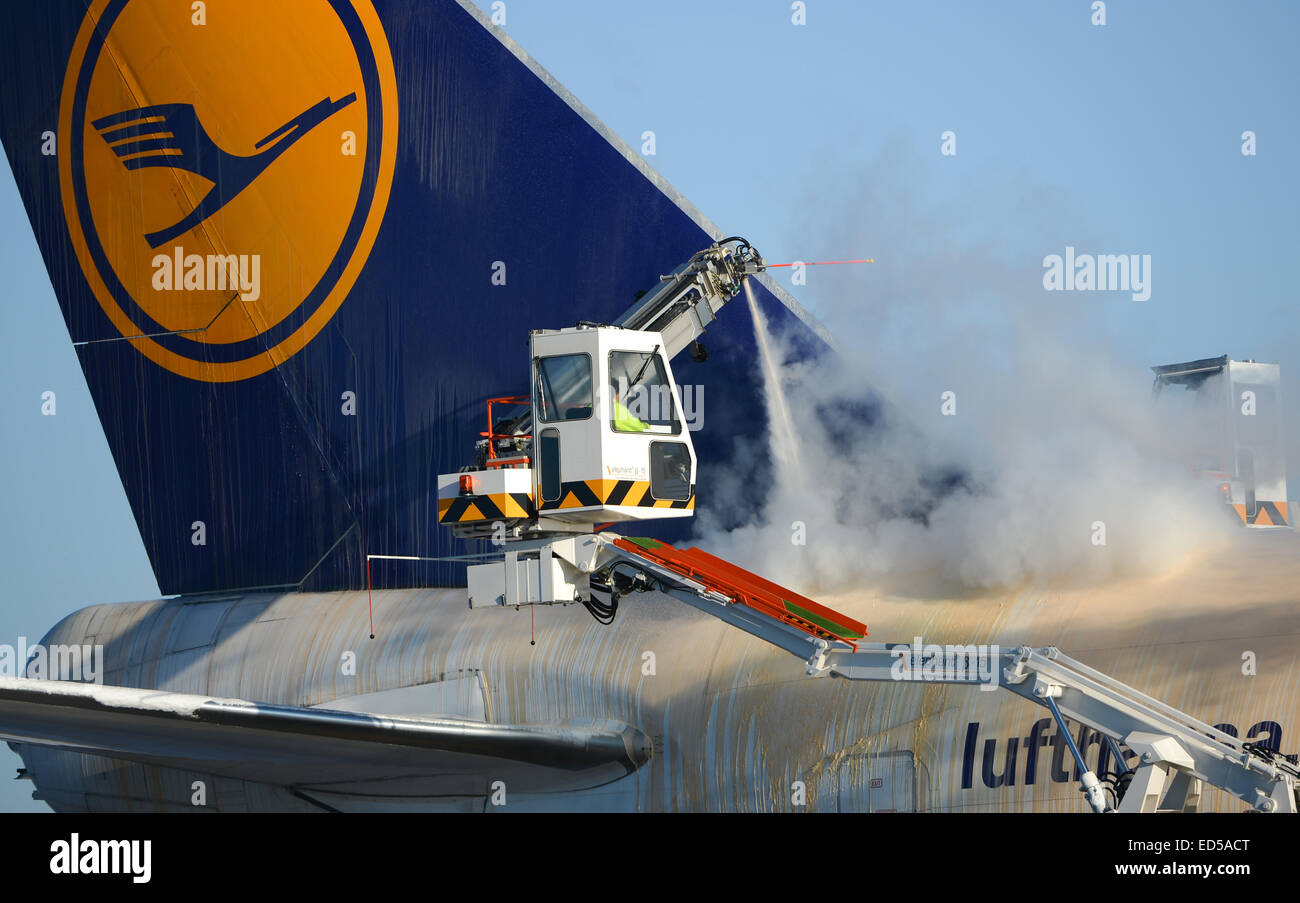 A Lufthansa Boeing 747-400 of is being de-iced before departure from ...