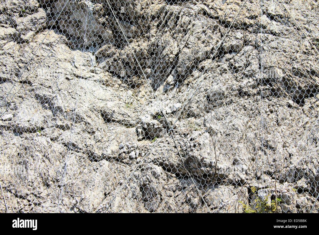 Rock face protected by metal wire netting Stock Photo - Alamy