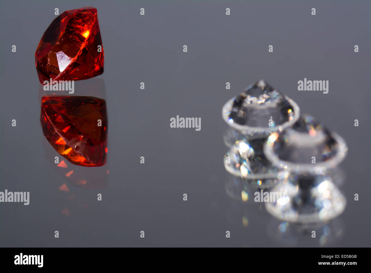 Ruby and diamond on a grey background Stock Photo - Alamy
