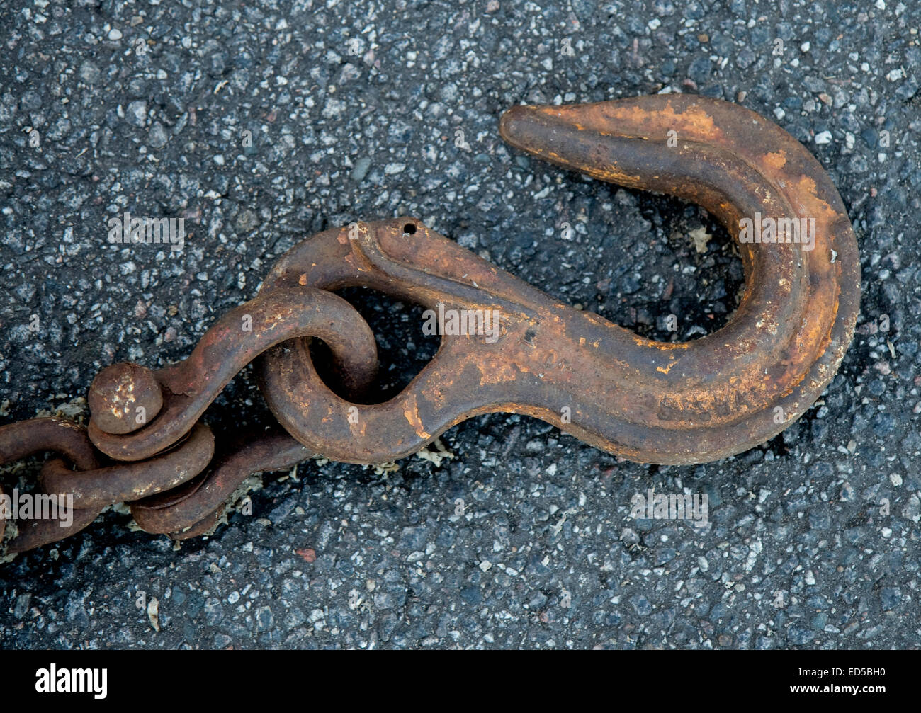 Rusty load hook on a background of asphalt Stock Photo - Alamy
